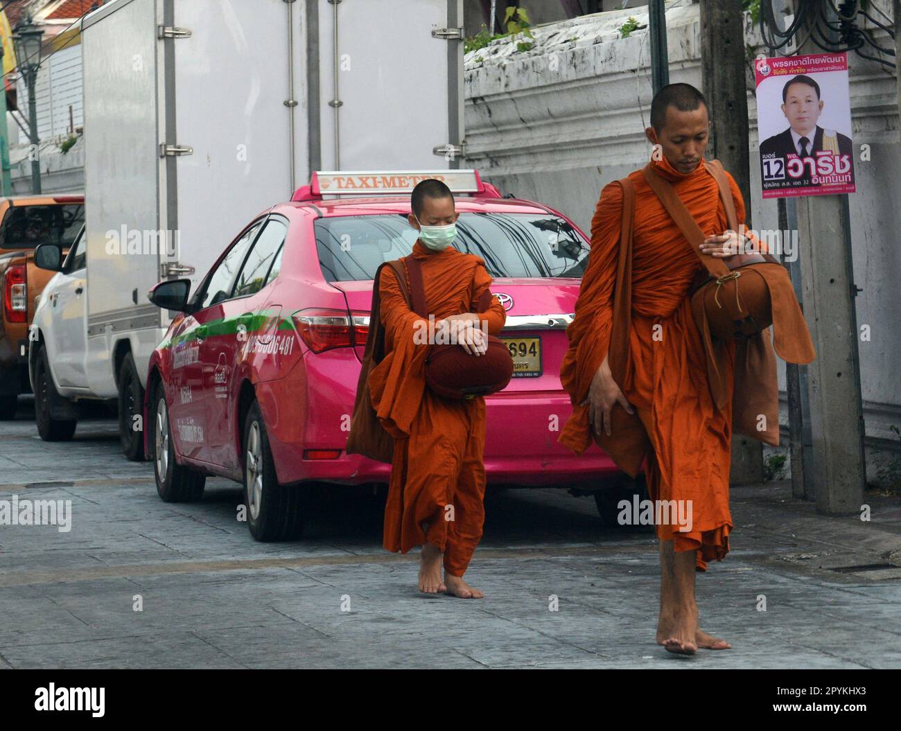 Thai Buddhist monks collecting alms as part of a morning ritual in ...