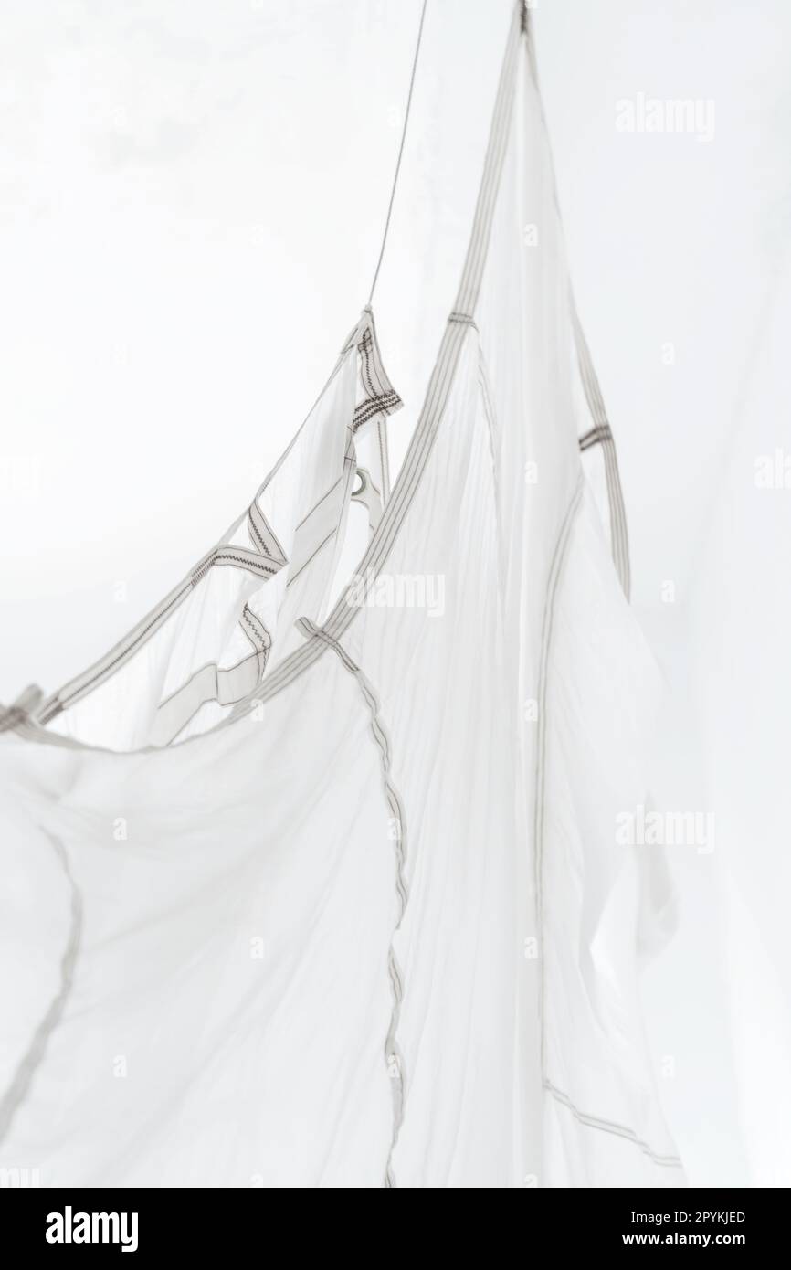 Segment of folded white parachute fabric closeup. Monochrome background ...