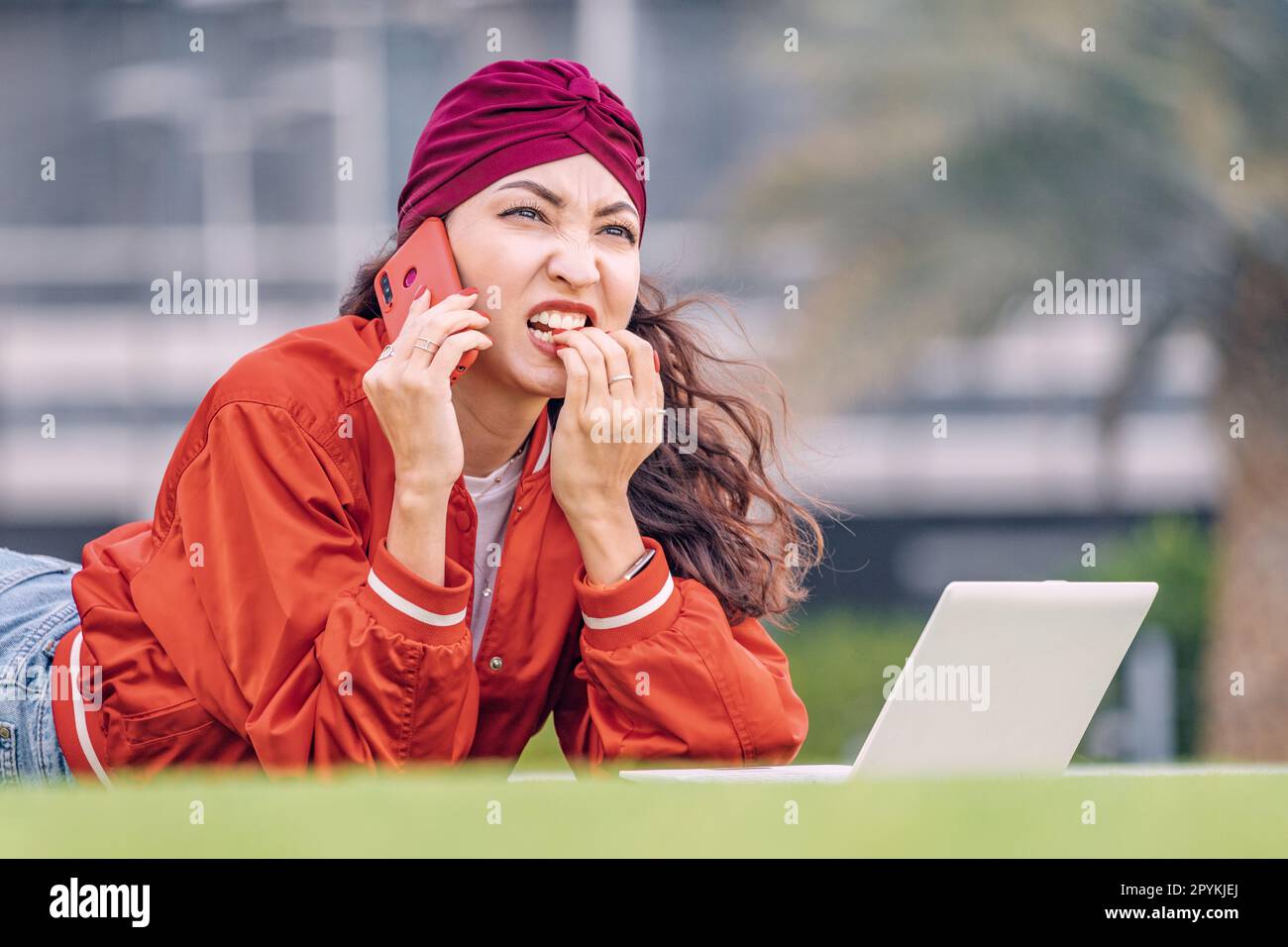 Frustrated And Scared Indian Woman Biting Her Nails Talk By Phone And Working Outdoor On Her