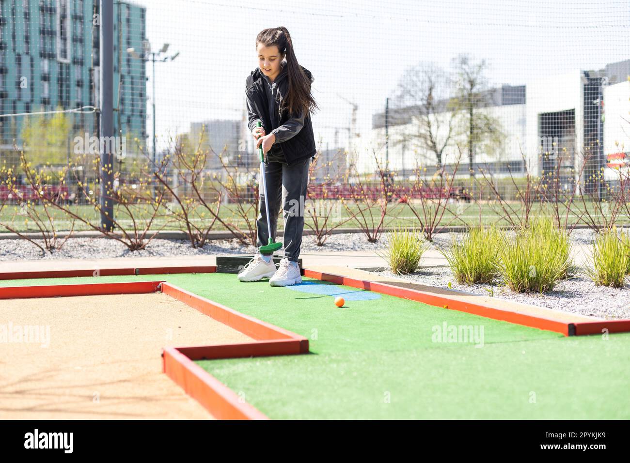 cute little girl on a miniature golf course Stock Photo - Alamy