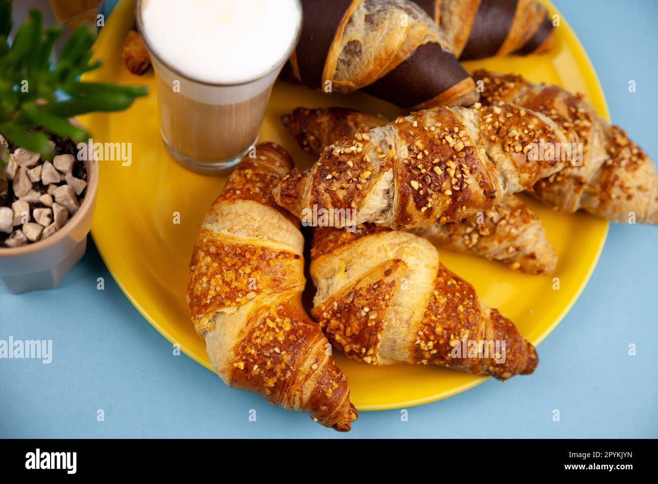 Chocolate croissants or croissant with nut crumbs on a plate. Delicious ...