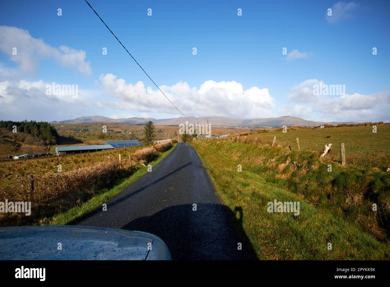 taking photo out of the car window along road less travelled in rural ...