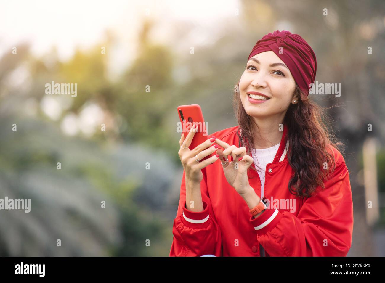 Malaysian girl using a smartphone application to stay connected to the ...