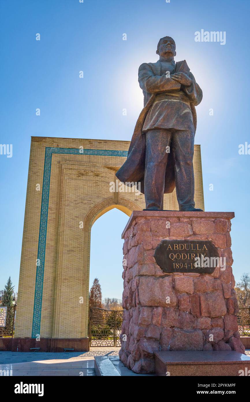 A large bronze sculpture of a standing Abdulla Qodiriy, famous writer ...