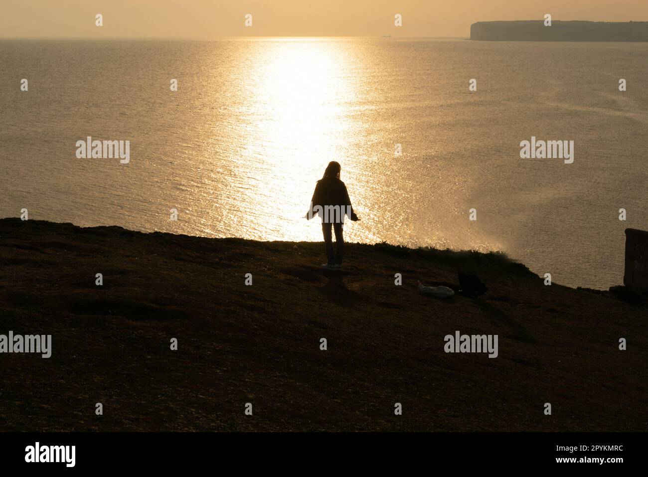 Girl Alone in Beachy Head Sunset Stock Photo - Alamy