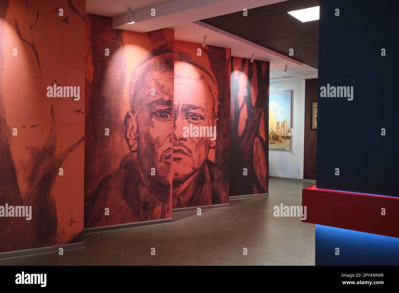 A large, split, red wall portrait of the famous writer, poet. At the ...