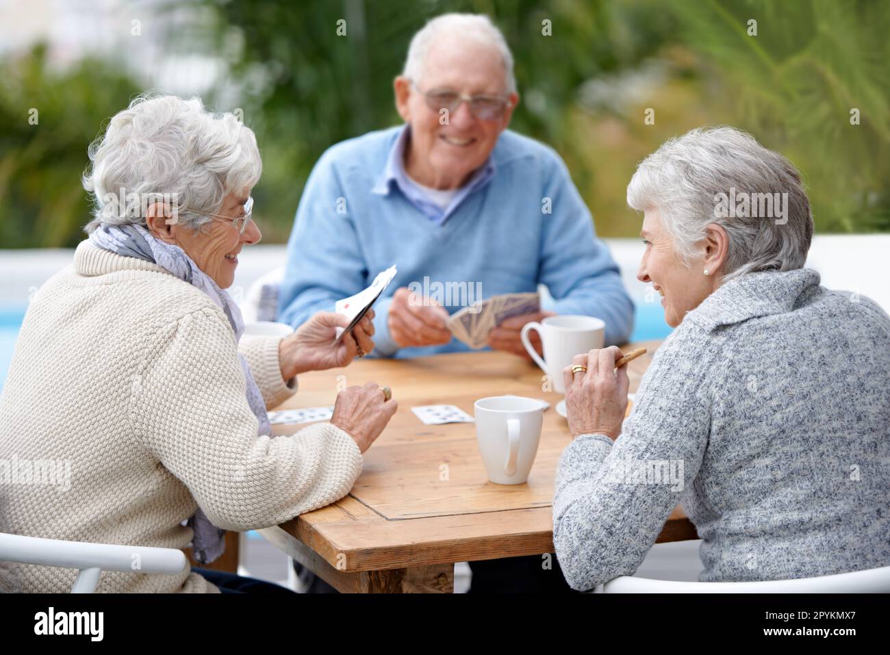 Poker, smile and senior group with retirement, outdoor and cheerful ...