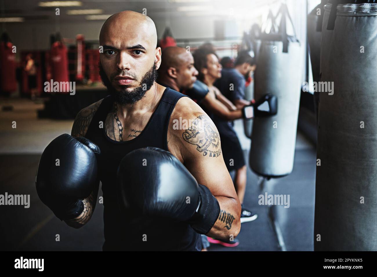 When life gets tough, put on your boxing gloves. a male boxer training ...