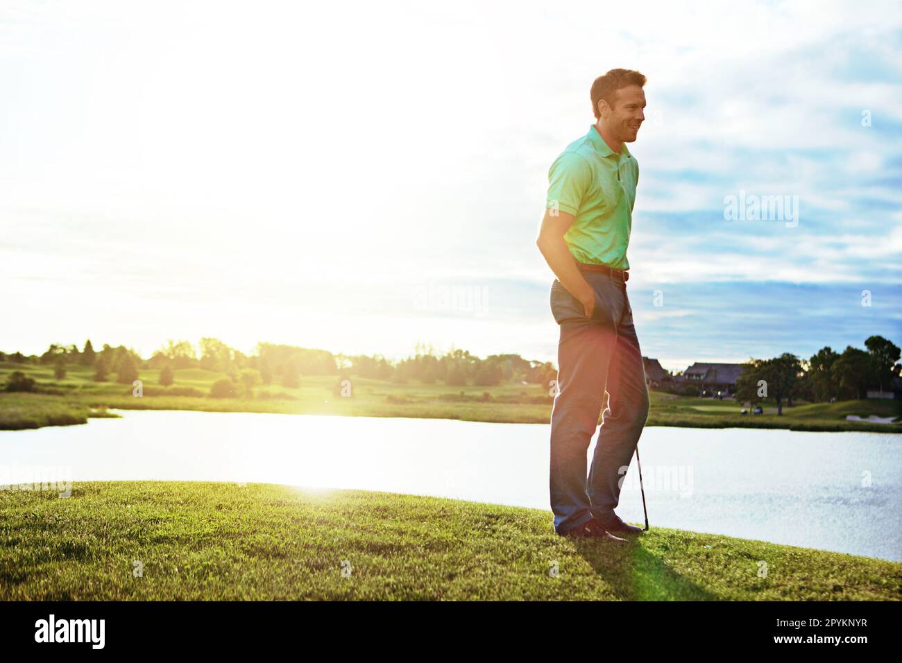 The perfect day to play. a young man spending the day on a golf course ...