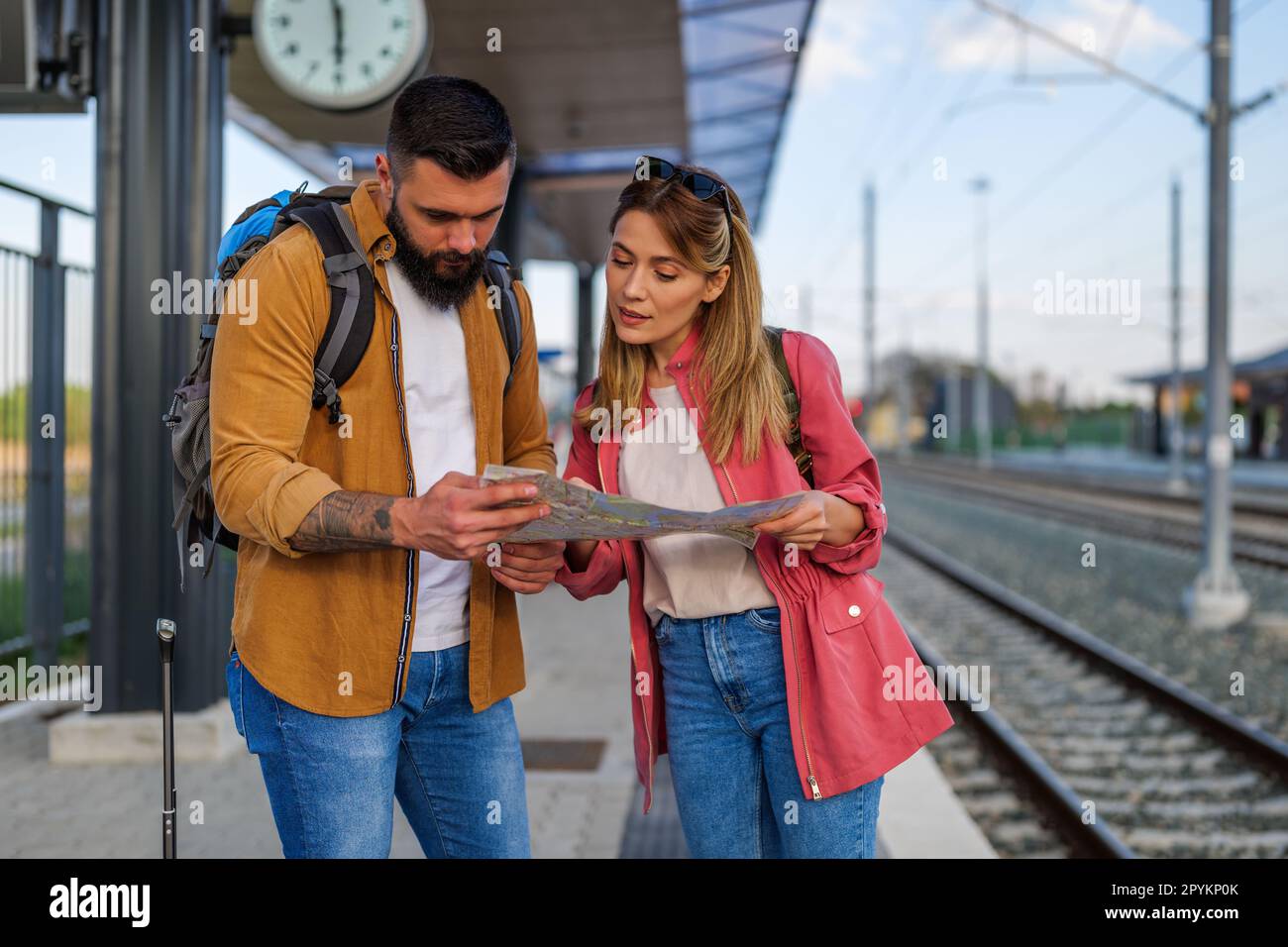Couple is standing at railway station and waiting for arrival of their ...