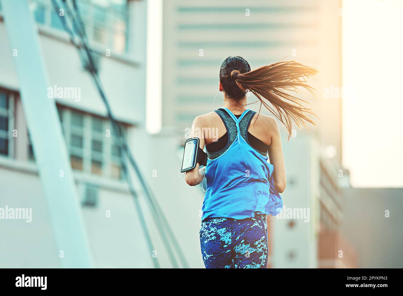 Just keep going. a young woman out in the city for her morning run ...