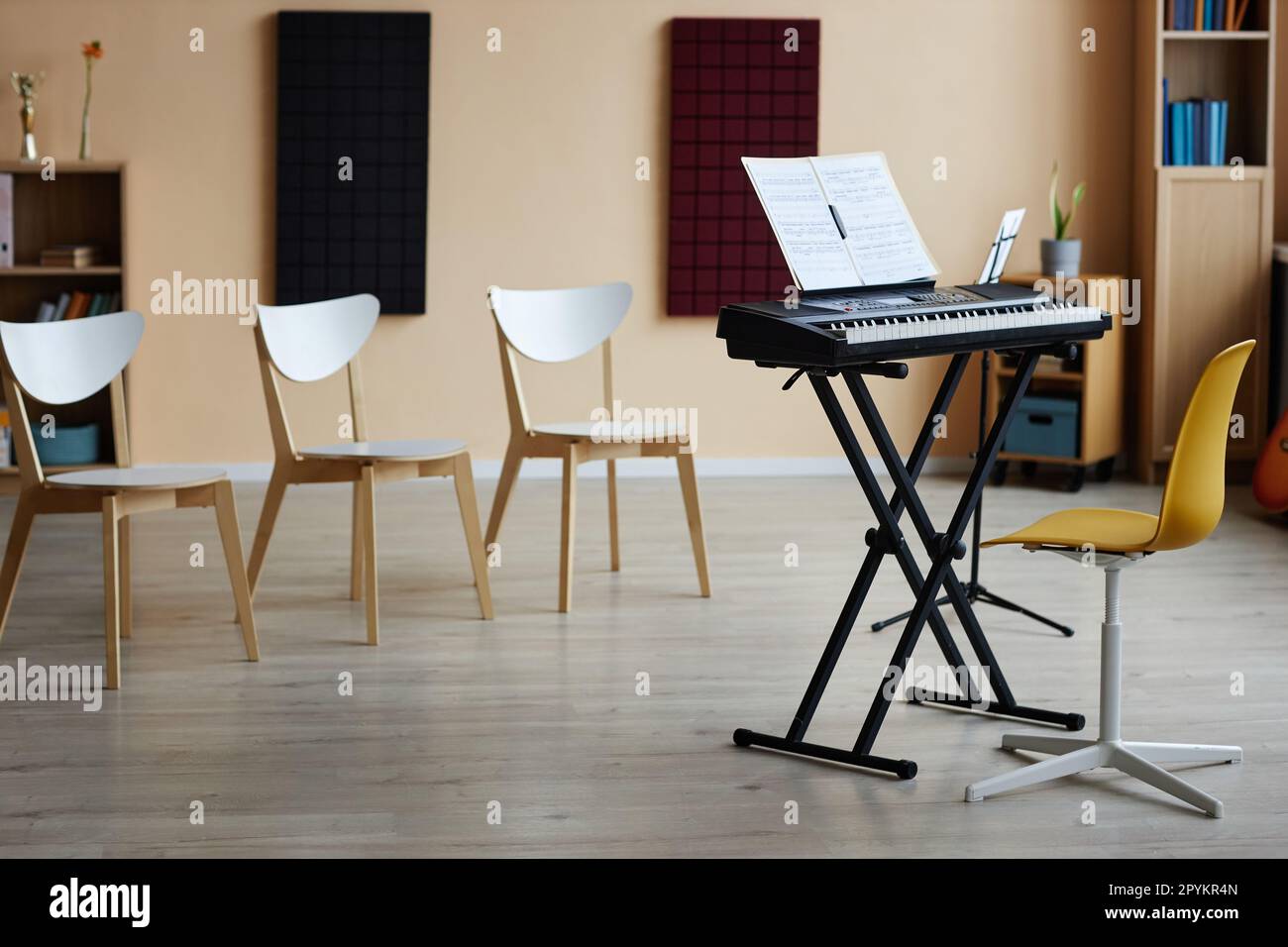 Horizontal image of empty music class with synthesizer and sheet music ...