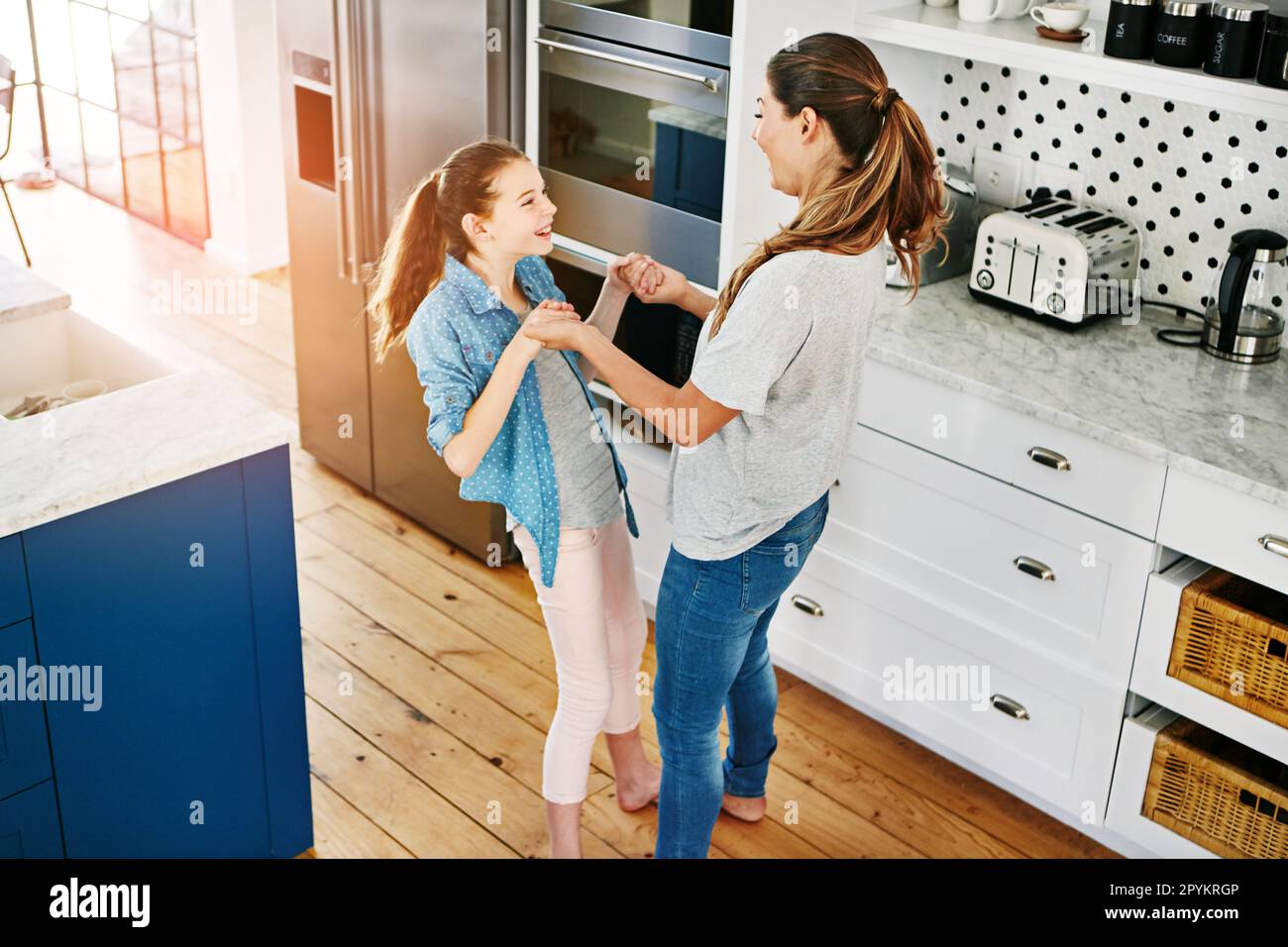 Come dance with me, Mom. a happy mother and daughter playfully dancing ...