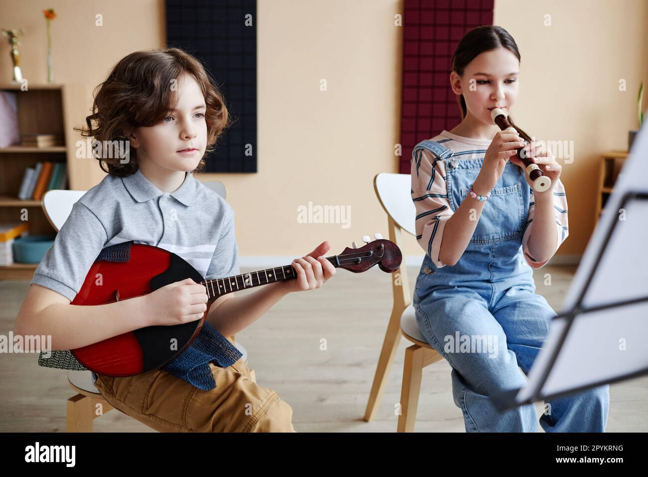 Children learning to play musical instruments during musical lesson in ...
