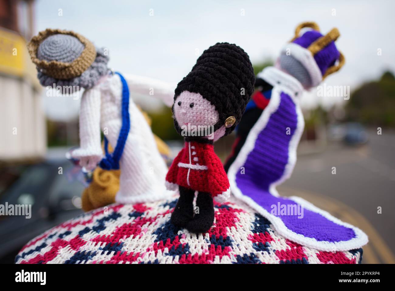 A knitted post box topper celebrating the coronation of King CharlesIII ...