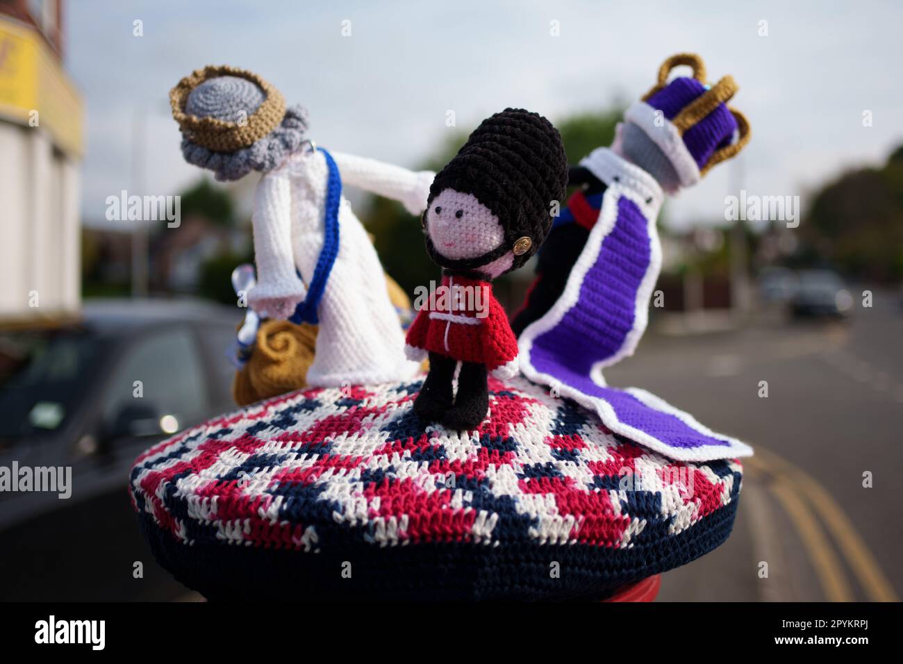 A knitted post box topper celebrating the coronation of King CharlesIII ...