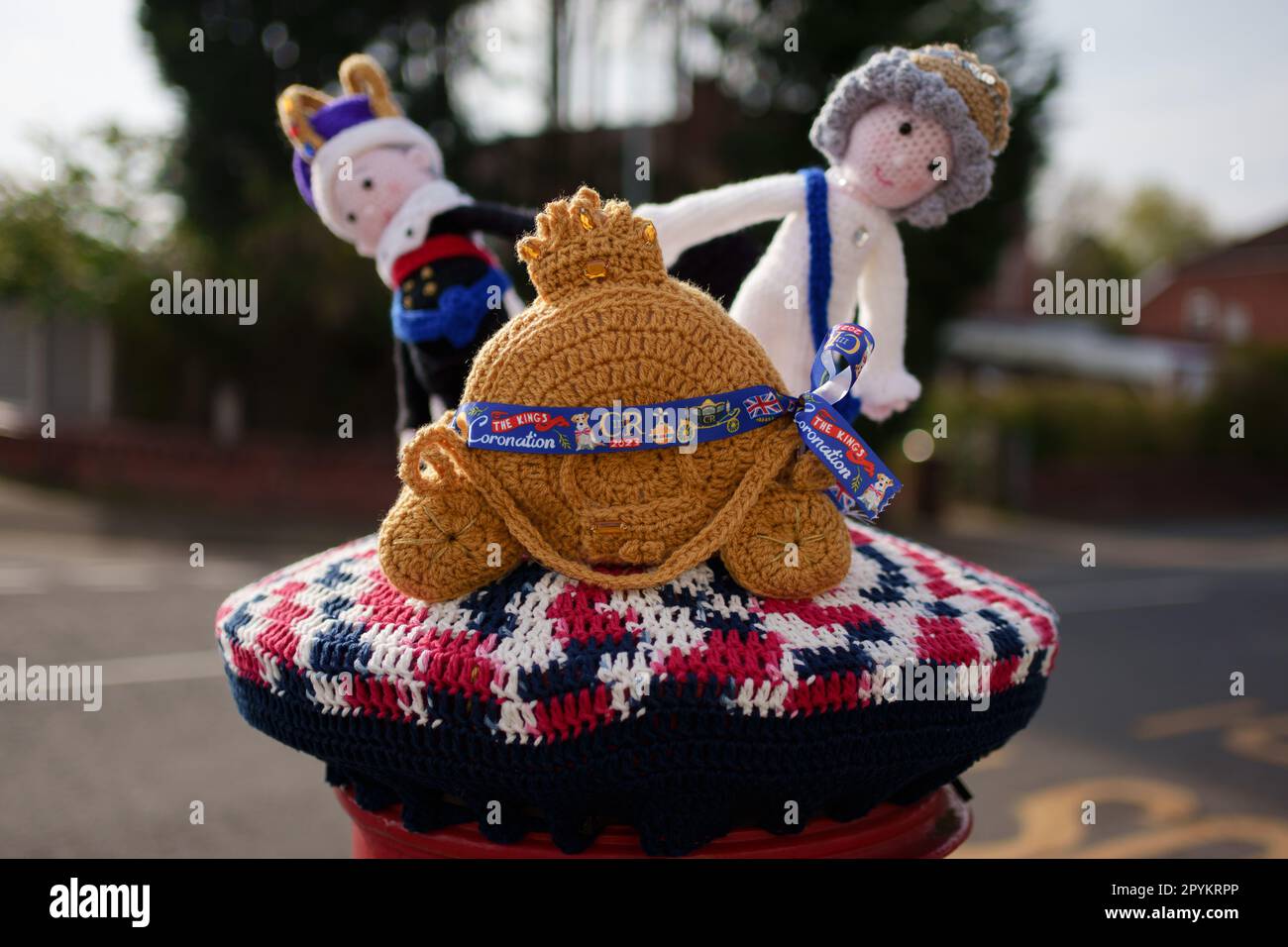 A knitted post box topper celebrating the coronation of King CharlesIII ...