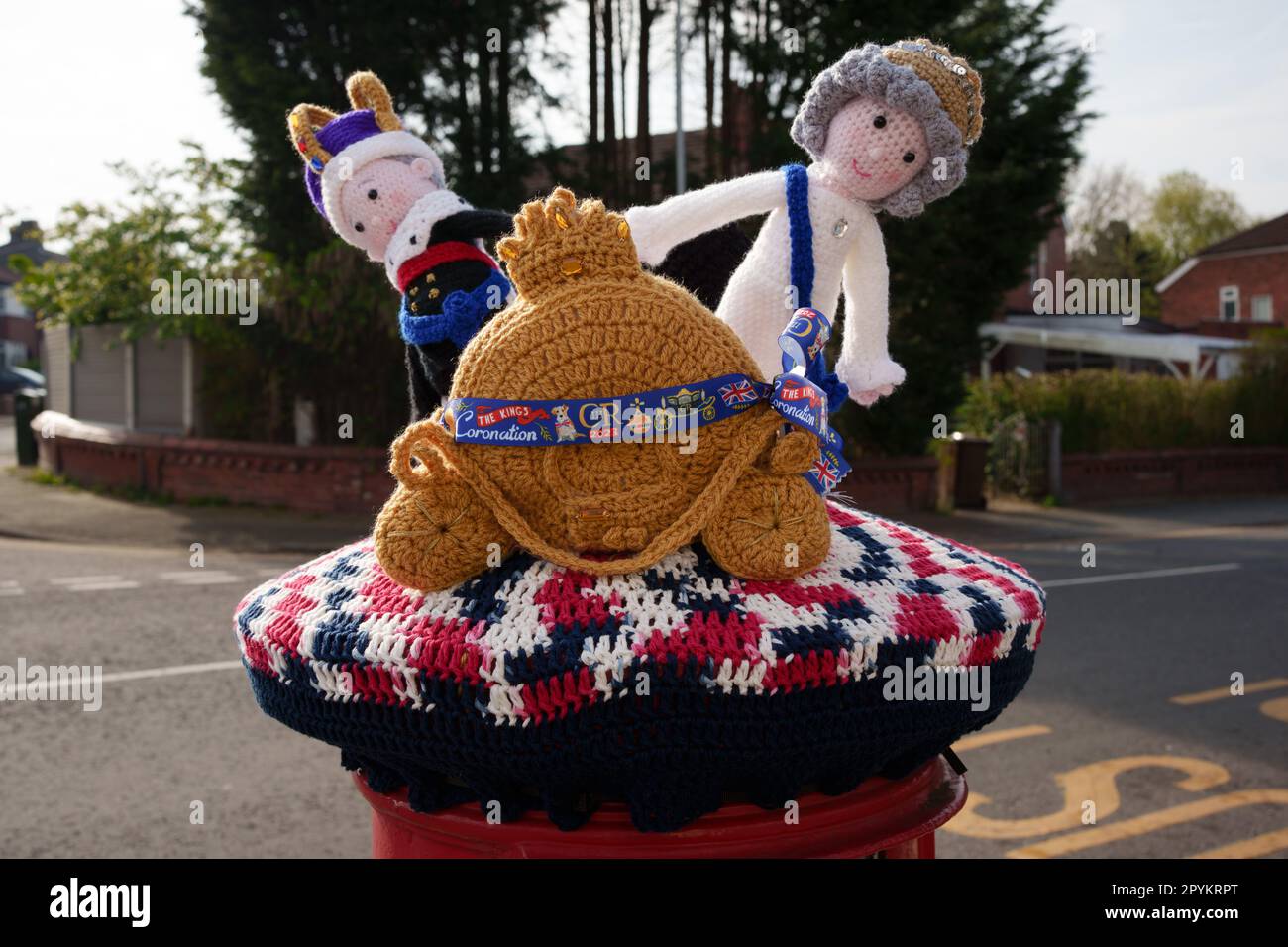 A knitted post box topper celebrating the coronation of King CharlesIII ...