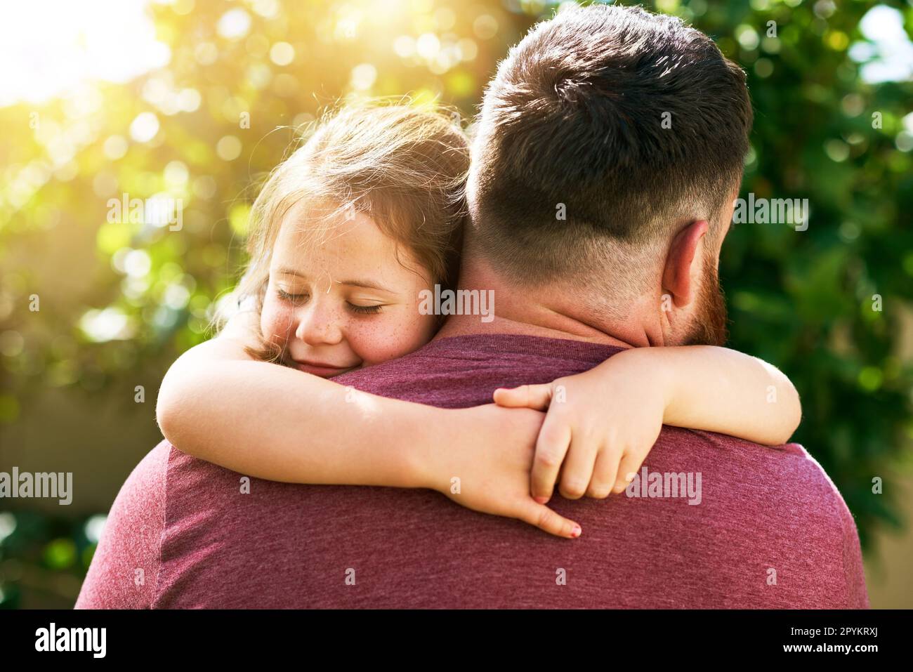 Dads bear hugs are the best. an adorable little girl giving her father ...
