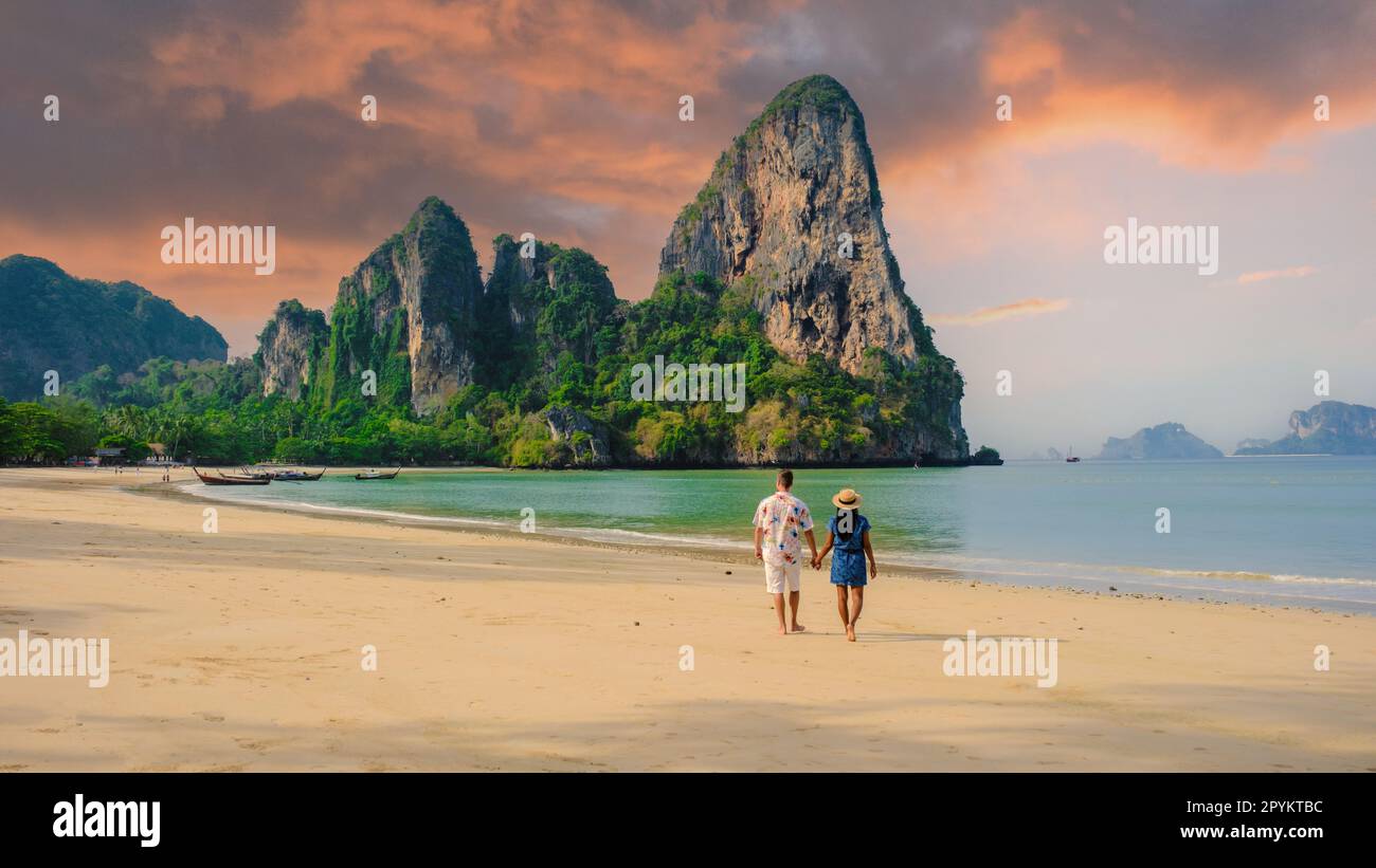 a couple of men and women relaxing on the beach during a vacation in ...