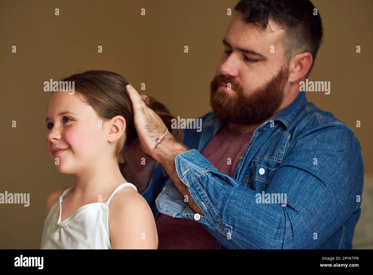 Hairdo by Dad. a father brushing his daughters hair at home Stock Photo ...