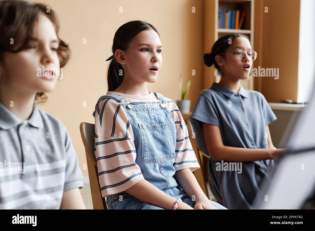 Choir of children singing songs during music lesson in class Stock ...