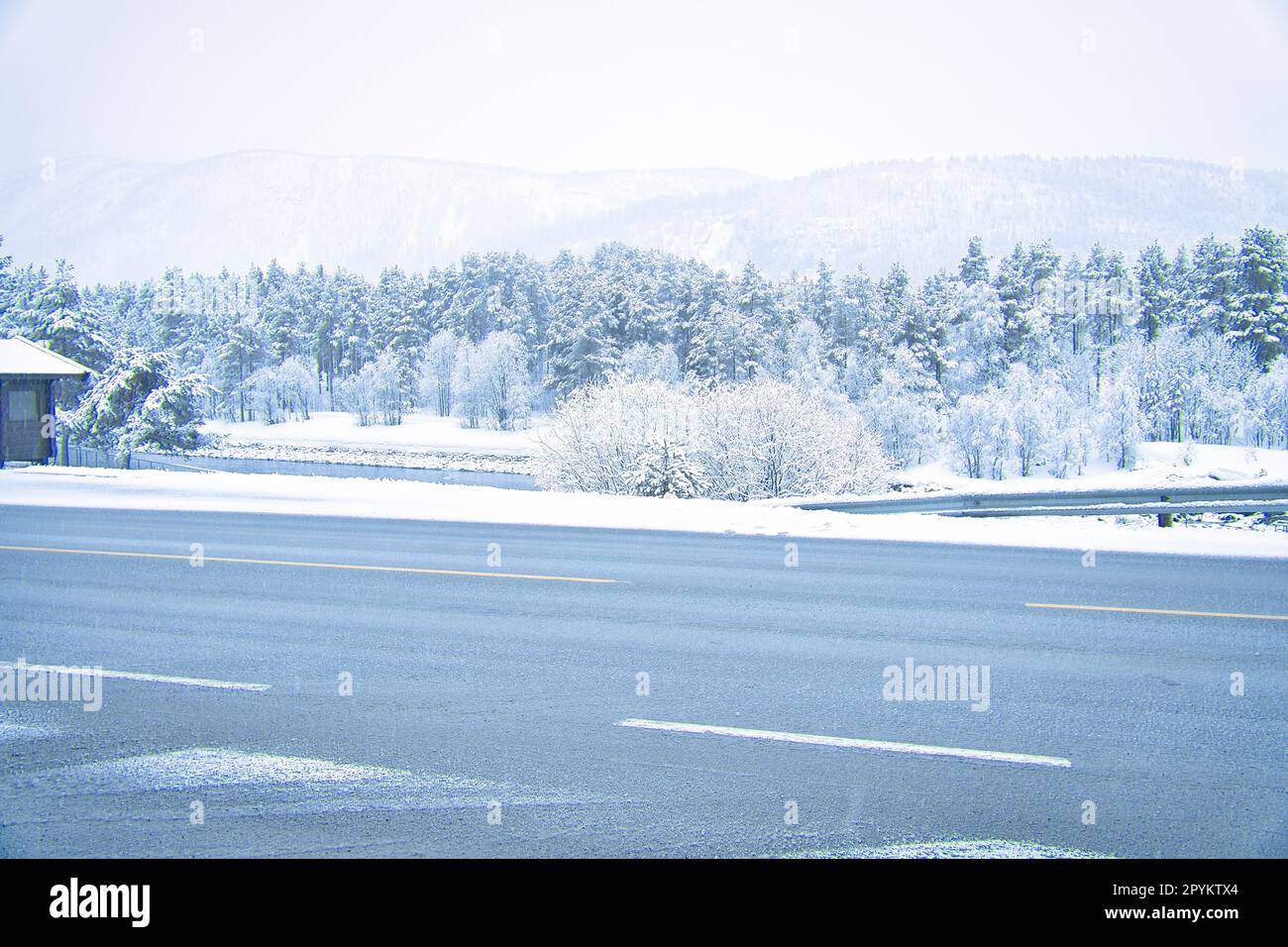 Winter landscape in Scandinavia. With snow covered trees on a road ...