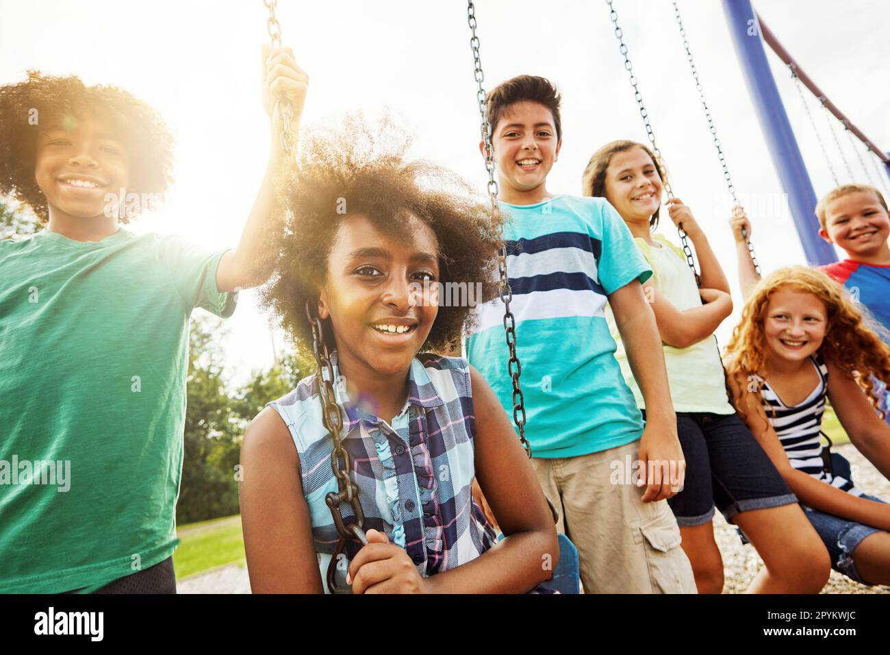 Youre welcome to hangout with us on the swings. Portrait of a group of ...
