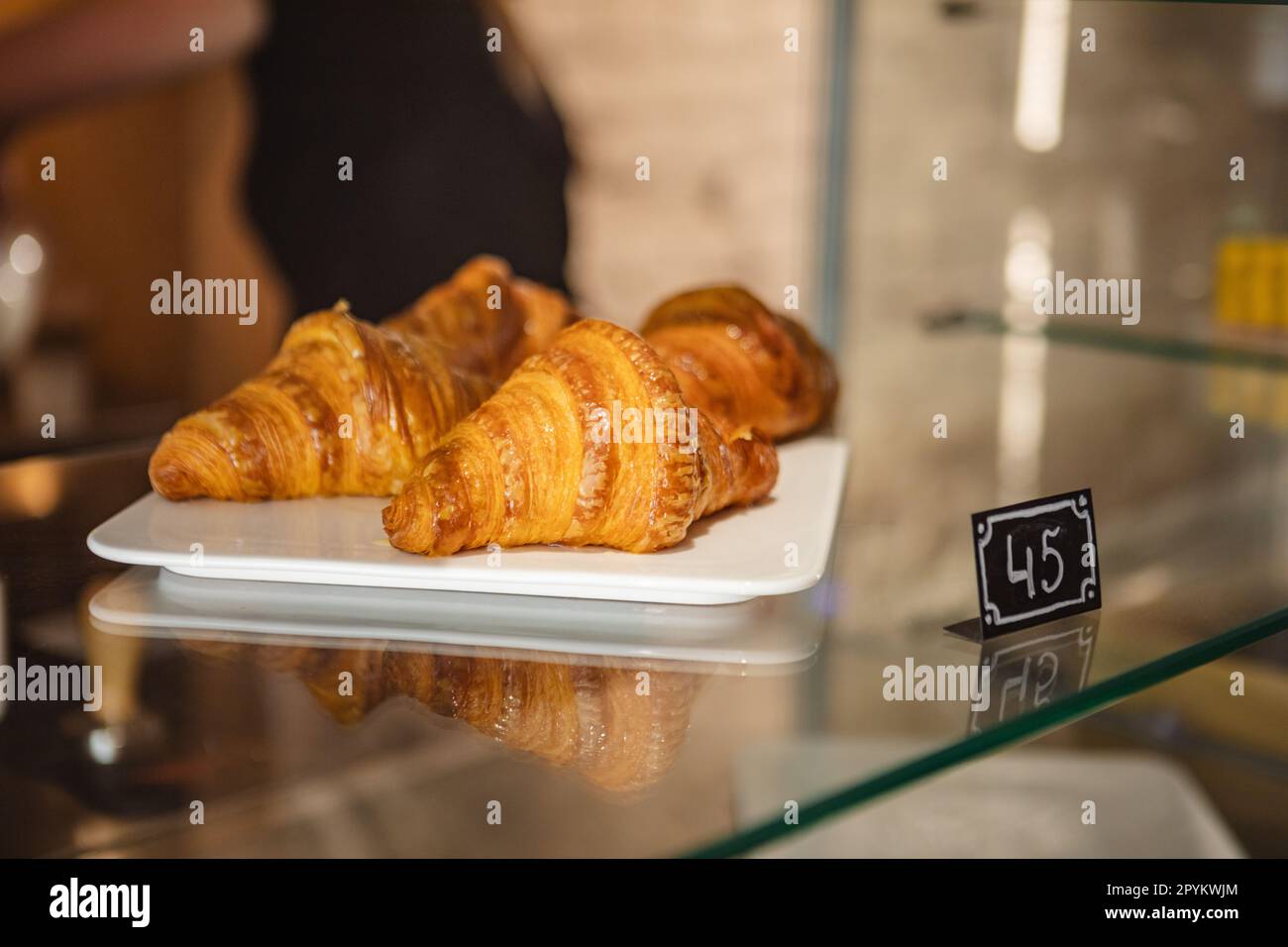 Fresh croissants displayed in bakery window Stock Photo - Alamy