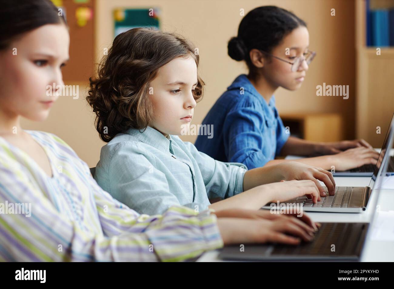 Group of school children concentrating on work on online presentation ...