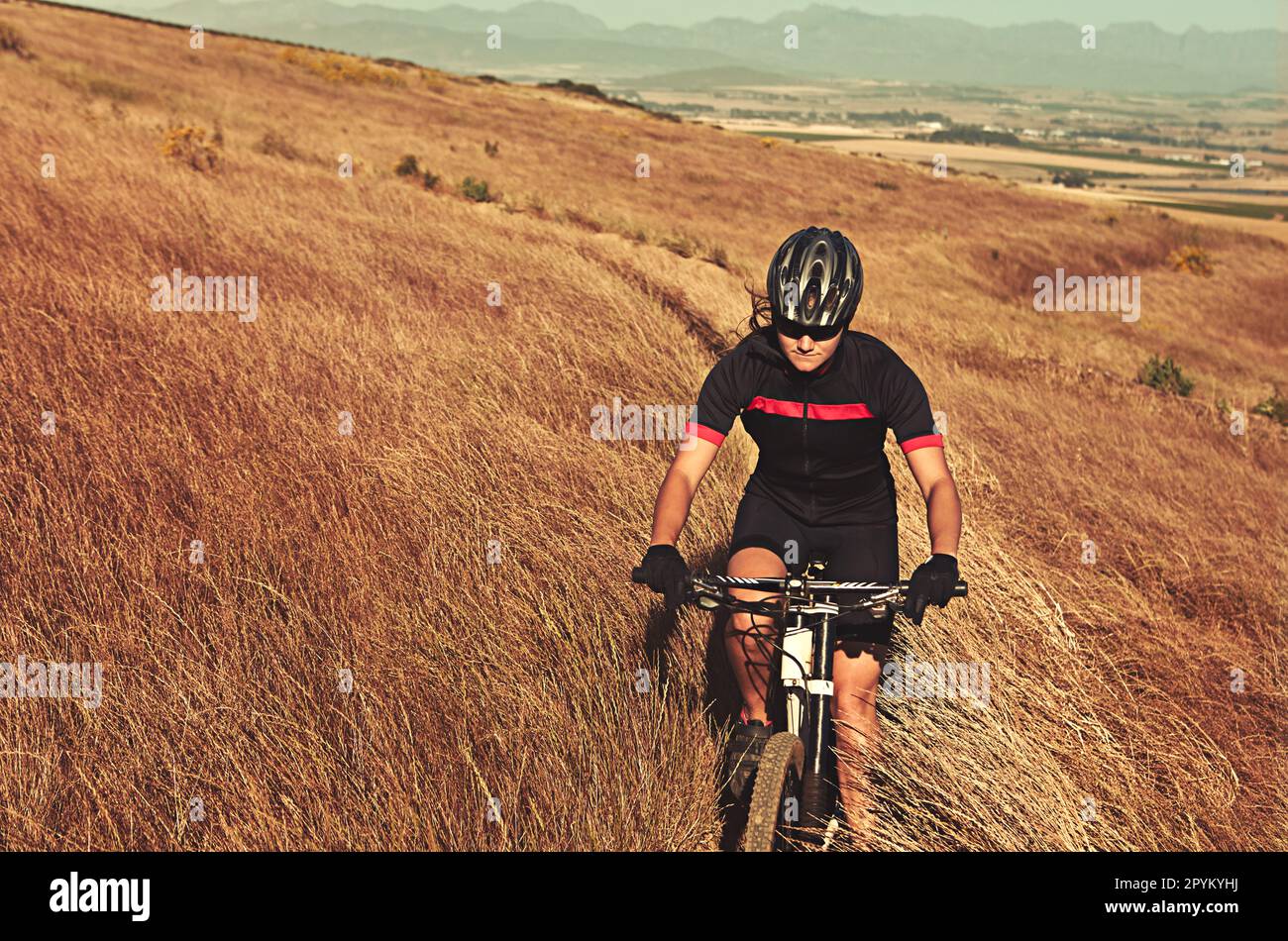 Trail riding is fun. an adventurous woman out cycling in the ...