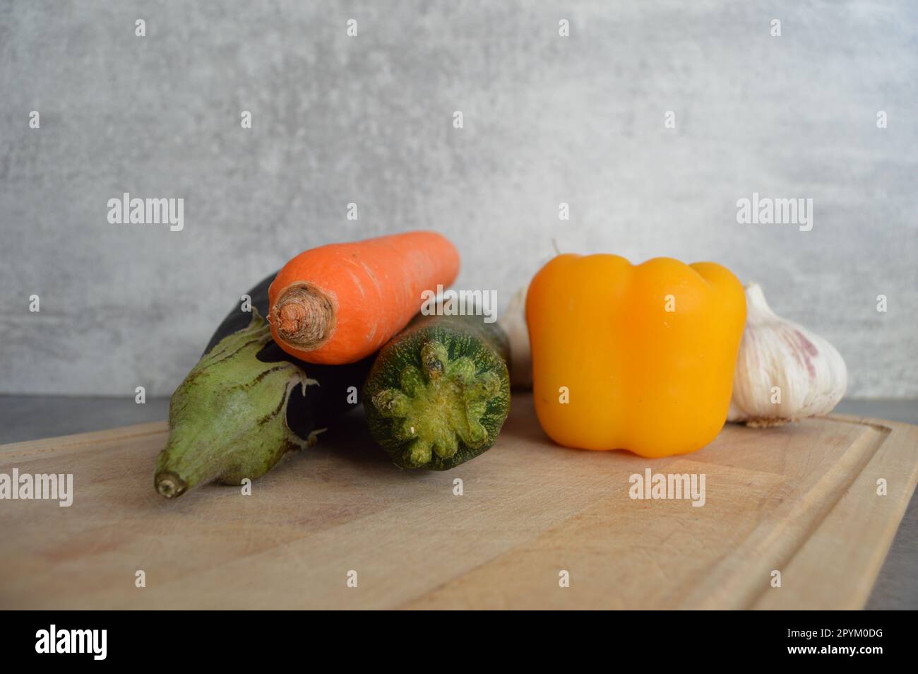Various fresh and colorful vegetables on a light wooden board in a ...