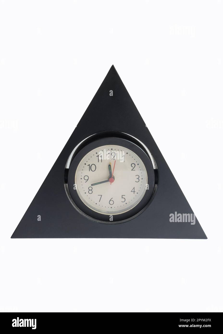 An old plastic black clock in the shape of a pyramid, isolated on a ...
