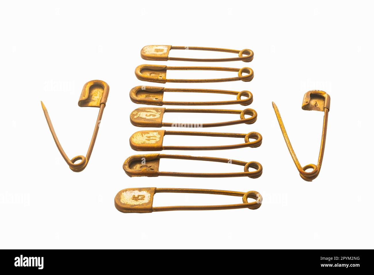 An old and rusty safety pin set isolated on white background Stock ...
