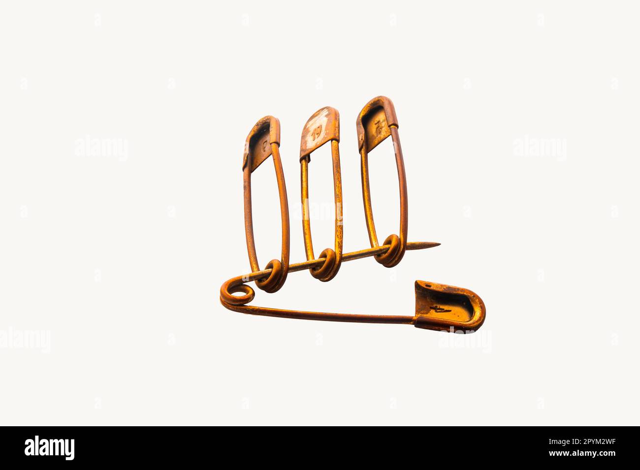 An old and rusty safety pin set isolated on white background Stock ...