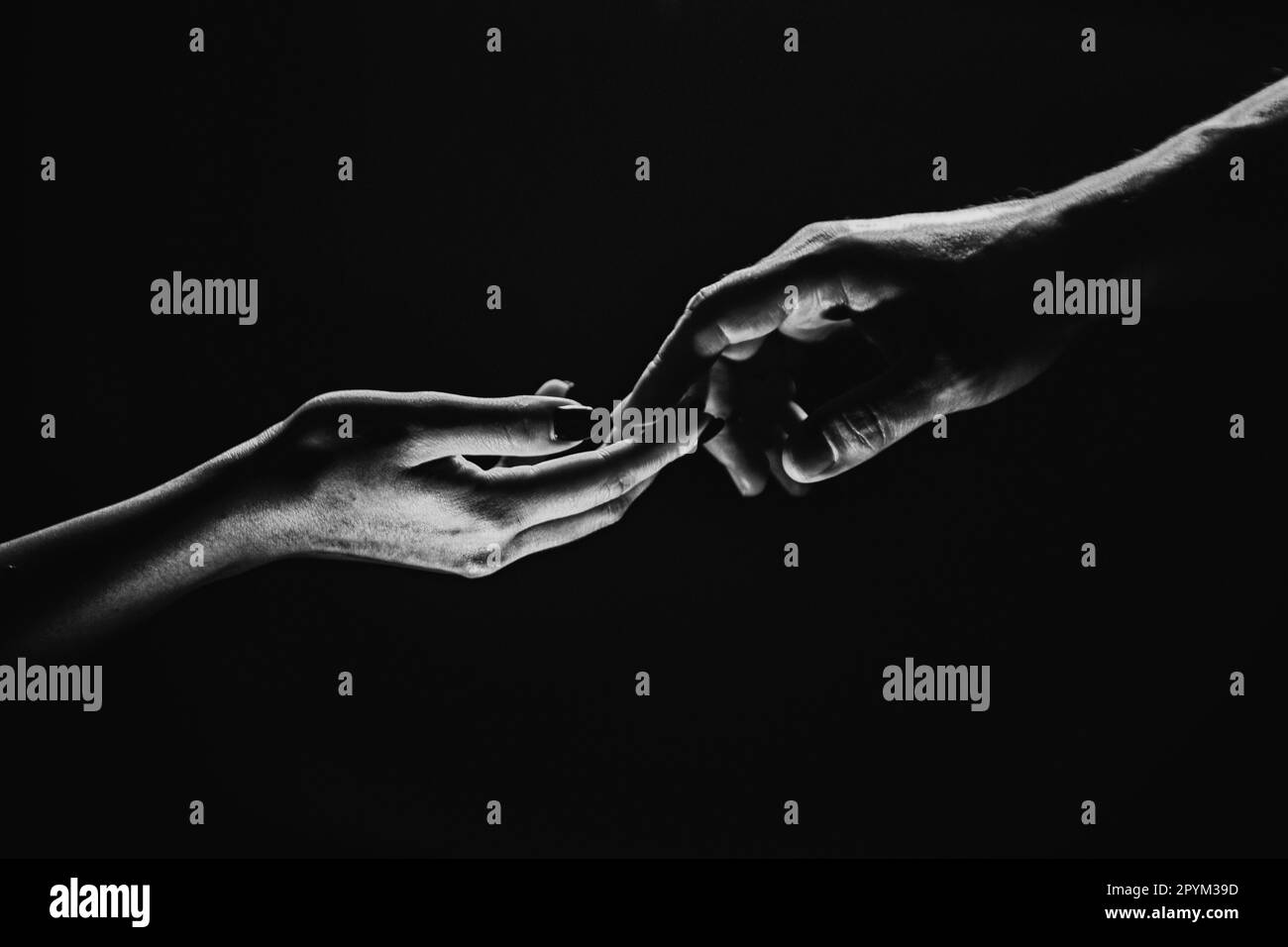Two hands reaching toward. Tenderness, tendet touch hands in black ...