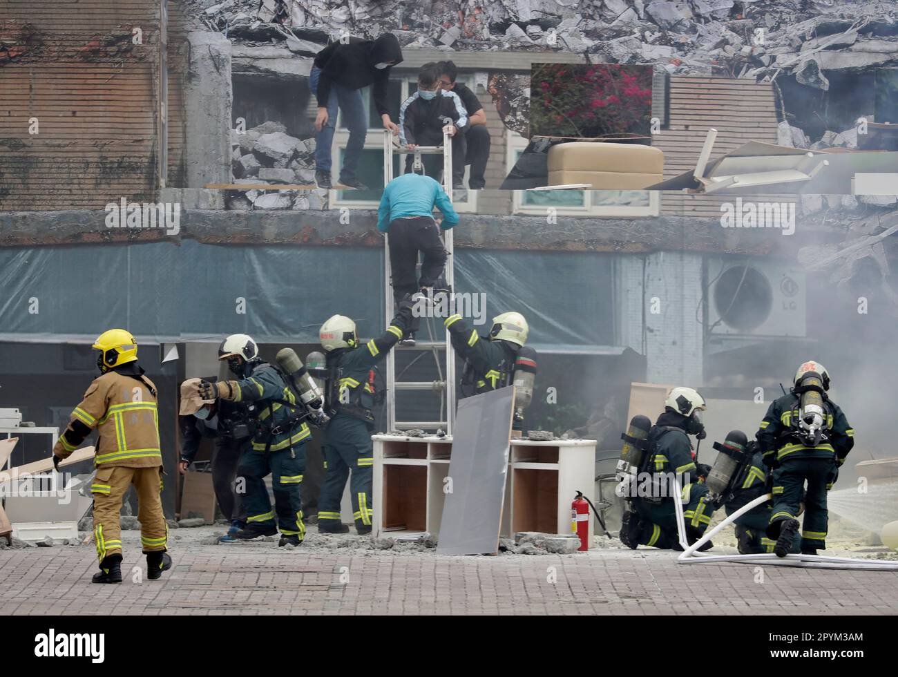 People rehearse the rescue operation at a damaged building scene during ...