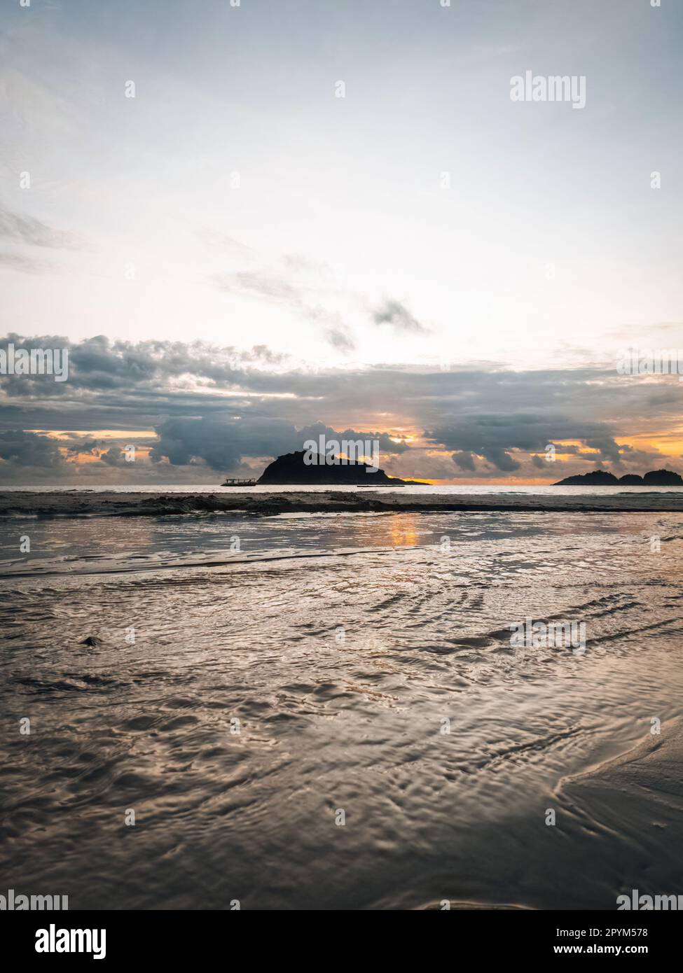 Sunrise on the beach sand. Textured and watery sandy beach Stock Photo ...