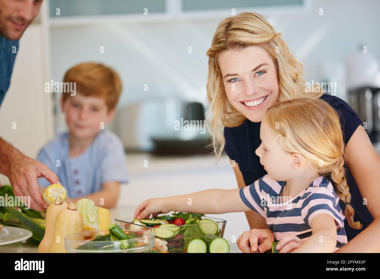 Cooking with the family. Portrait of a mother cooking together with her ...