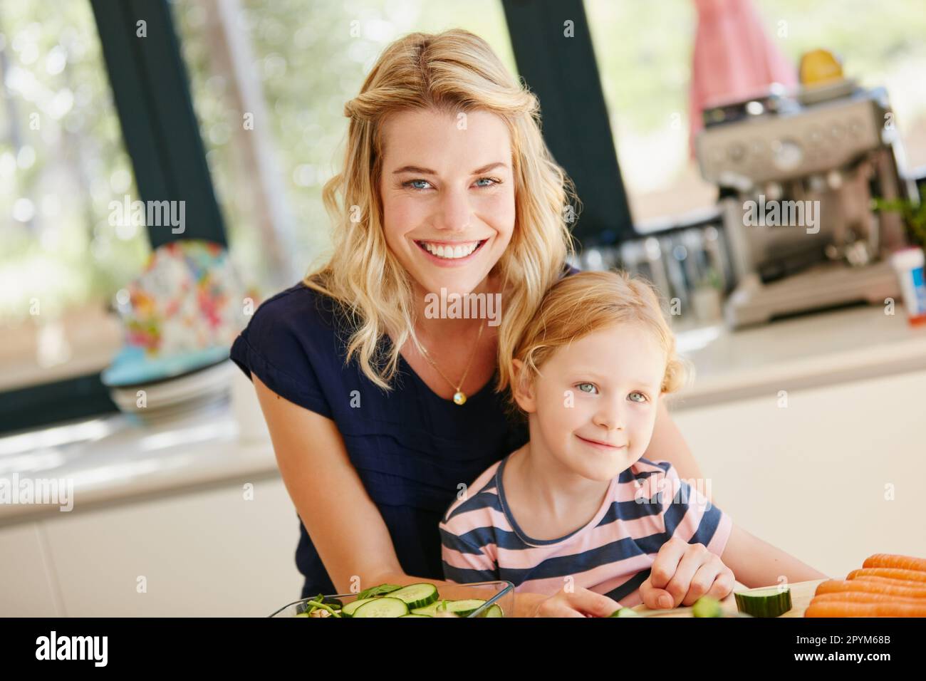 Mommys little helper. Portrait of a mother and daughter preparing a ...