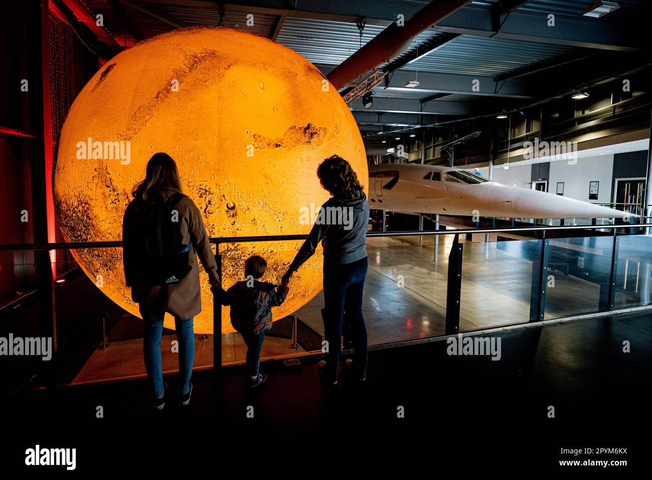 A family admire artist Luke Jerram's Mars installation at Aerospace ...