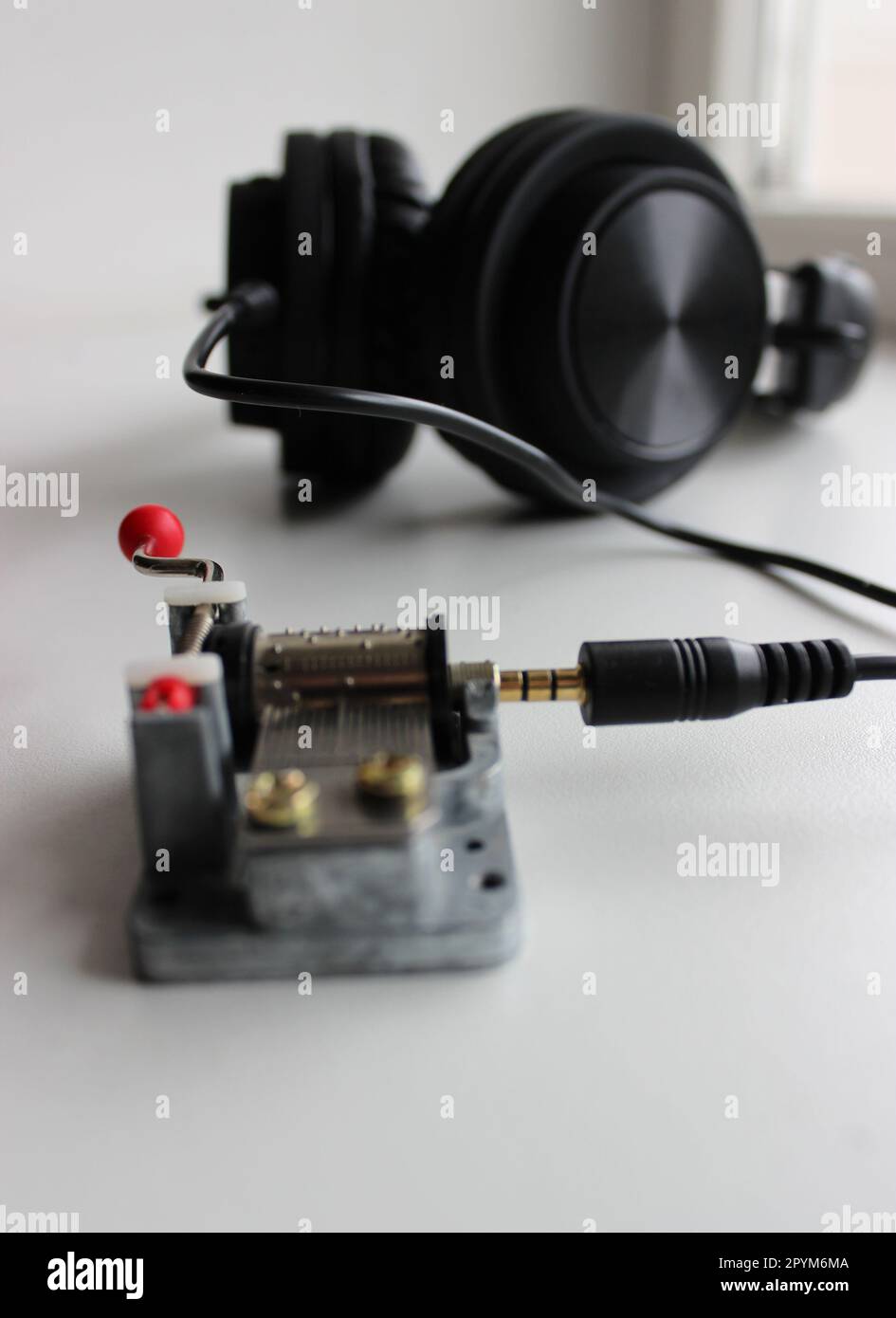 Modern Headphone And Vintage Hand Cranked Music Box Isolated On White ...