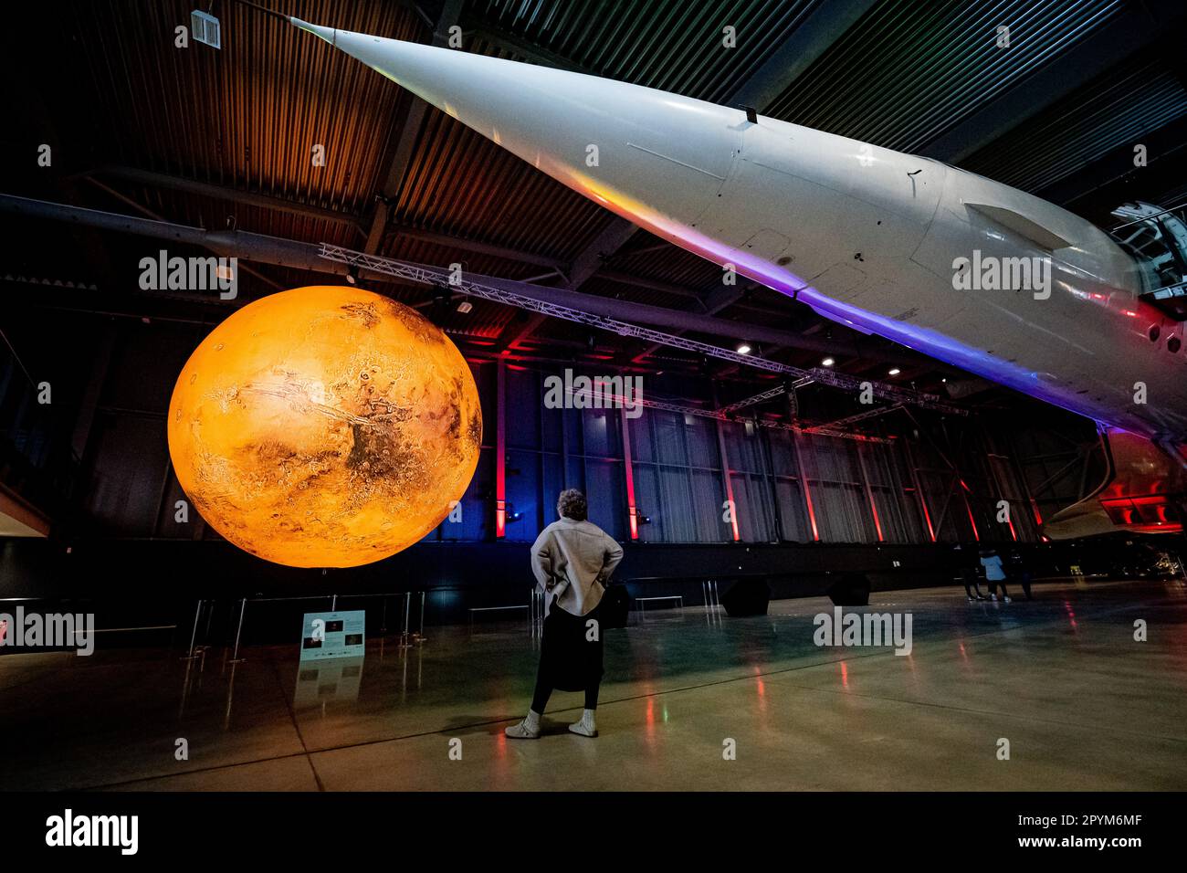 A person stands underneath the nose of Concorde and admires artist Luke ...