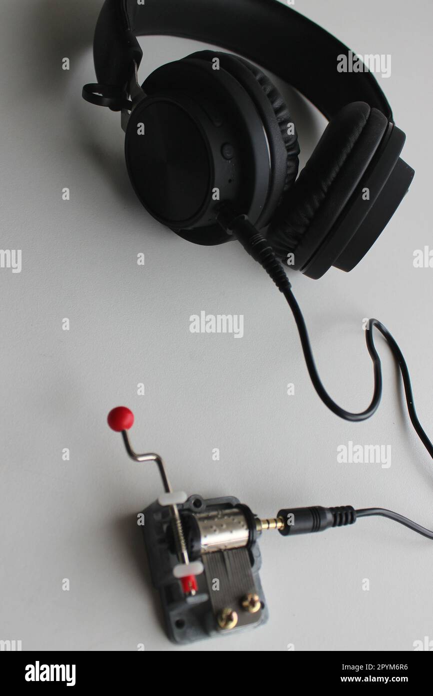 Crankshaft Mini Music Box And Music Headphones On White Surface With ...