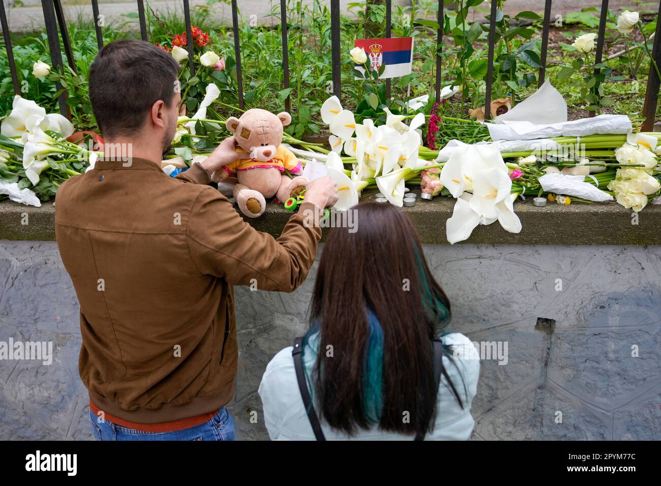 People lay flowers for the victims in front of the Vladimir Ribnikar ...