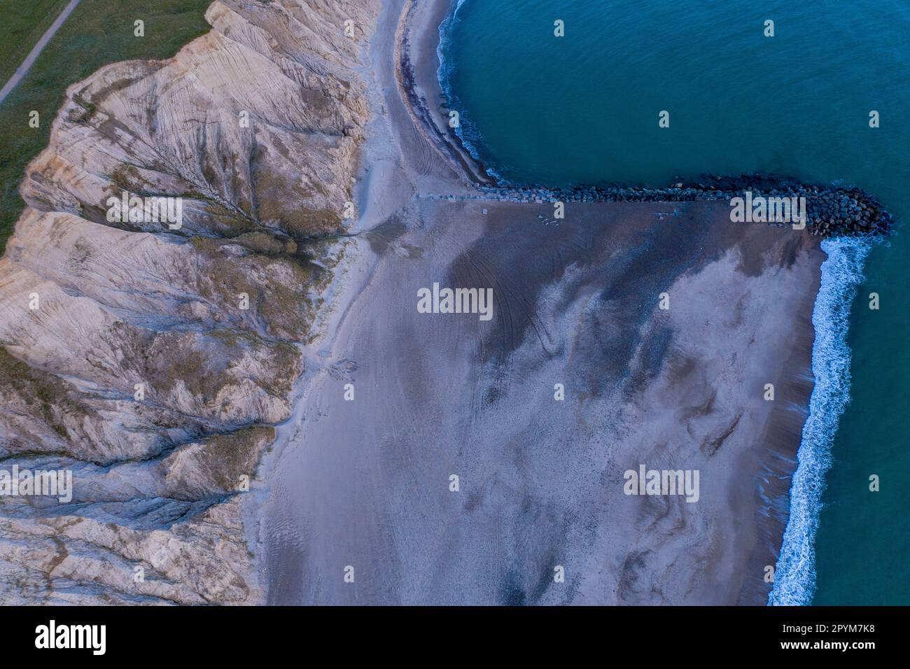 Aerial shot made with a drone of a rocky beach. The waves reaching the ...