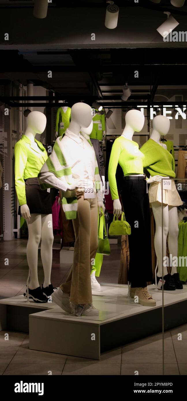 Mannequins on a lighted area in front of the entrance to a women's ...
