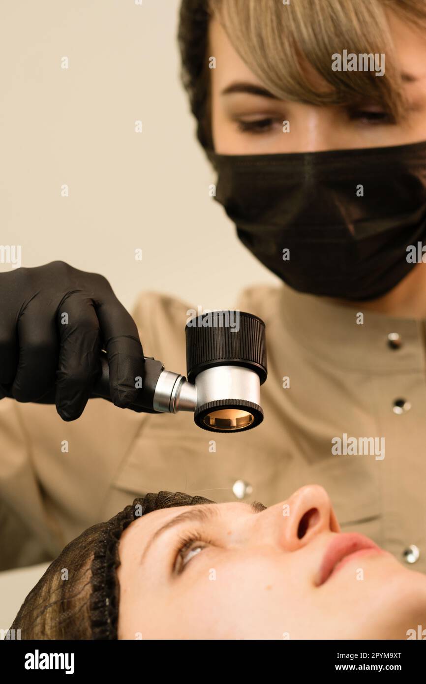 Dermatologist Doctor Examines Moles And Birthmarks Of Female Patient In