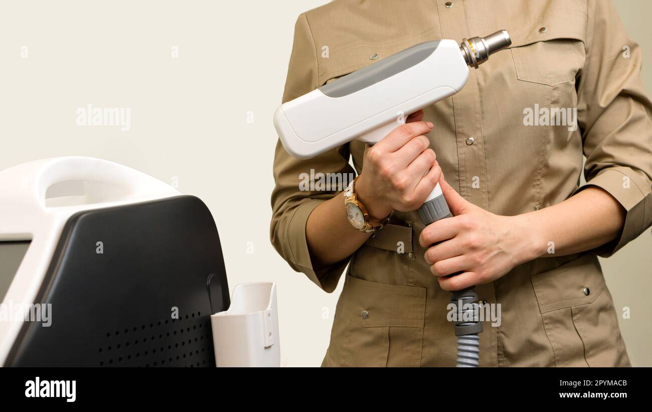 Сosmetologist holds hands maniple for carbon peeling and tattoo or ...