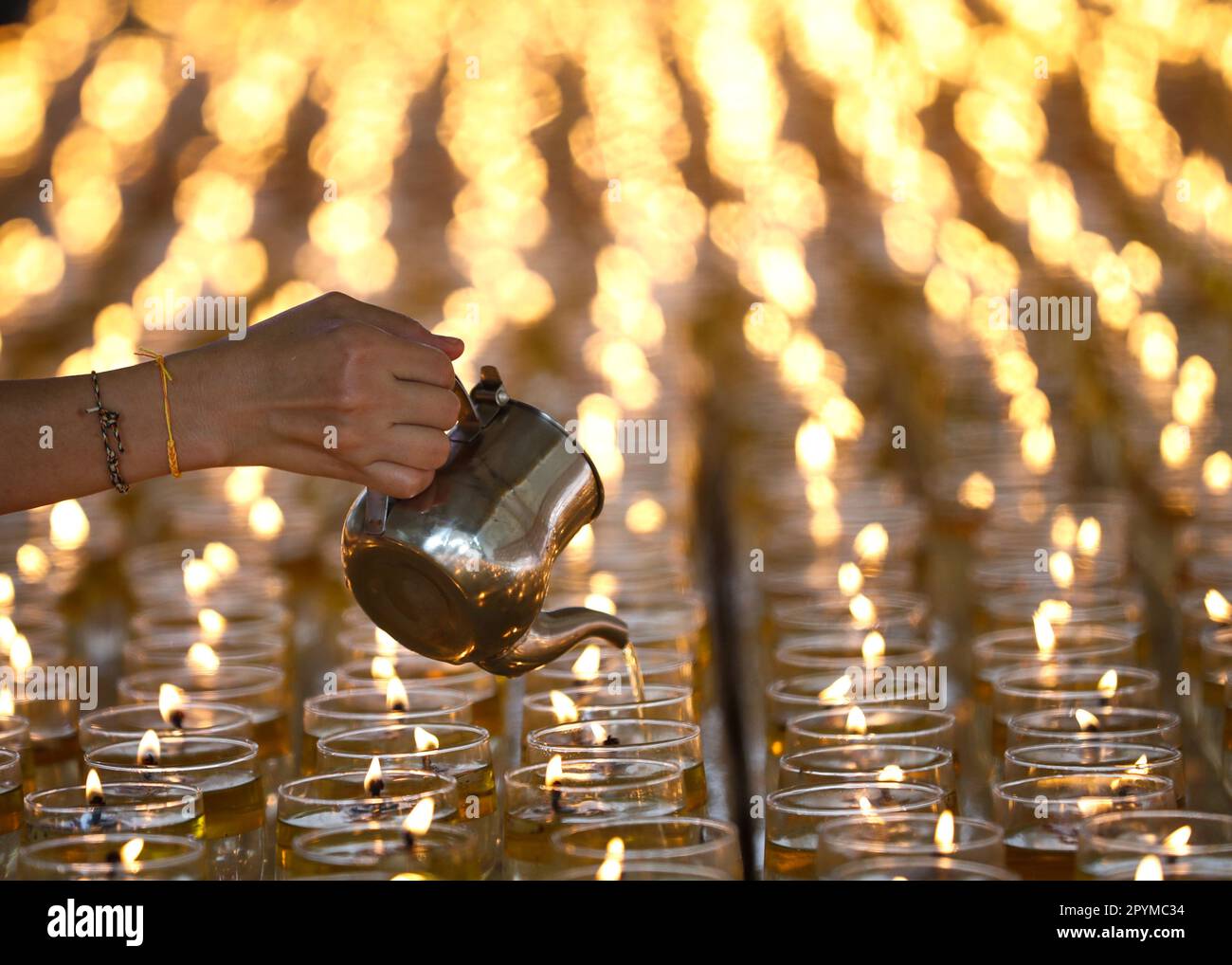 Kuala Lumpur, Malaysia. 04th May, 2023. A devotee lights the oil lamps ...